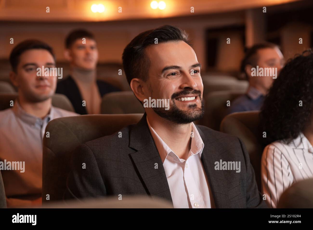 Group of people watching theatrical performance in theatre Stock Photo ...