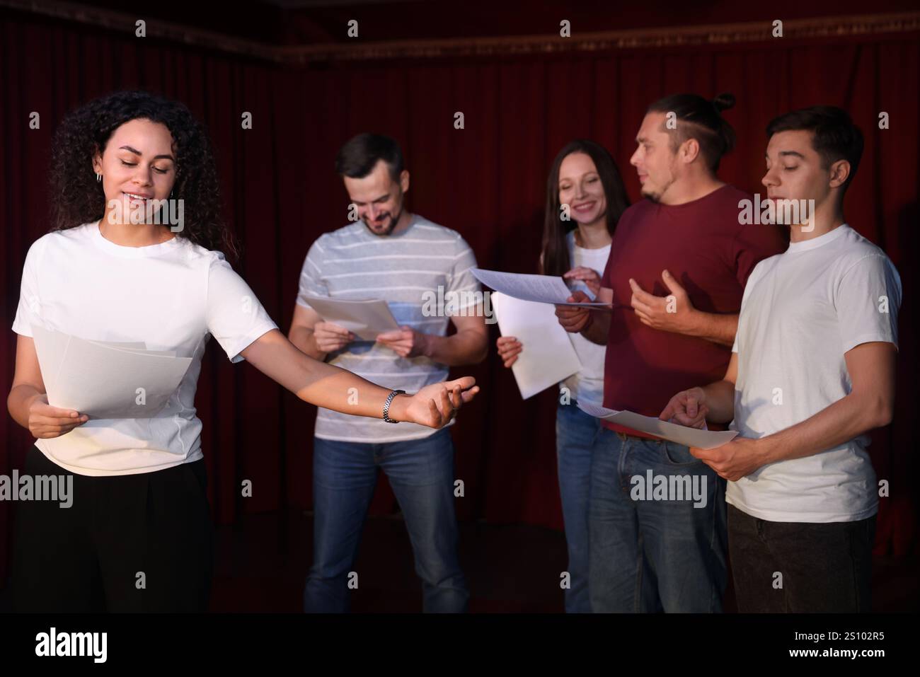 Professional actors with their scripts rehearsing in theatre Stock ...