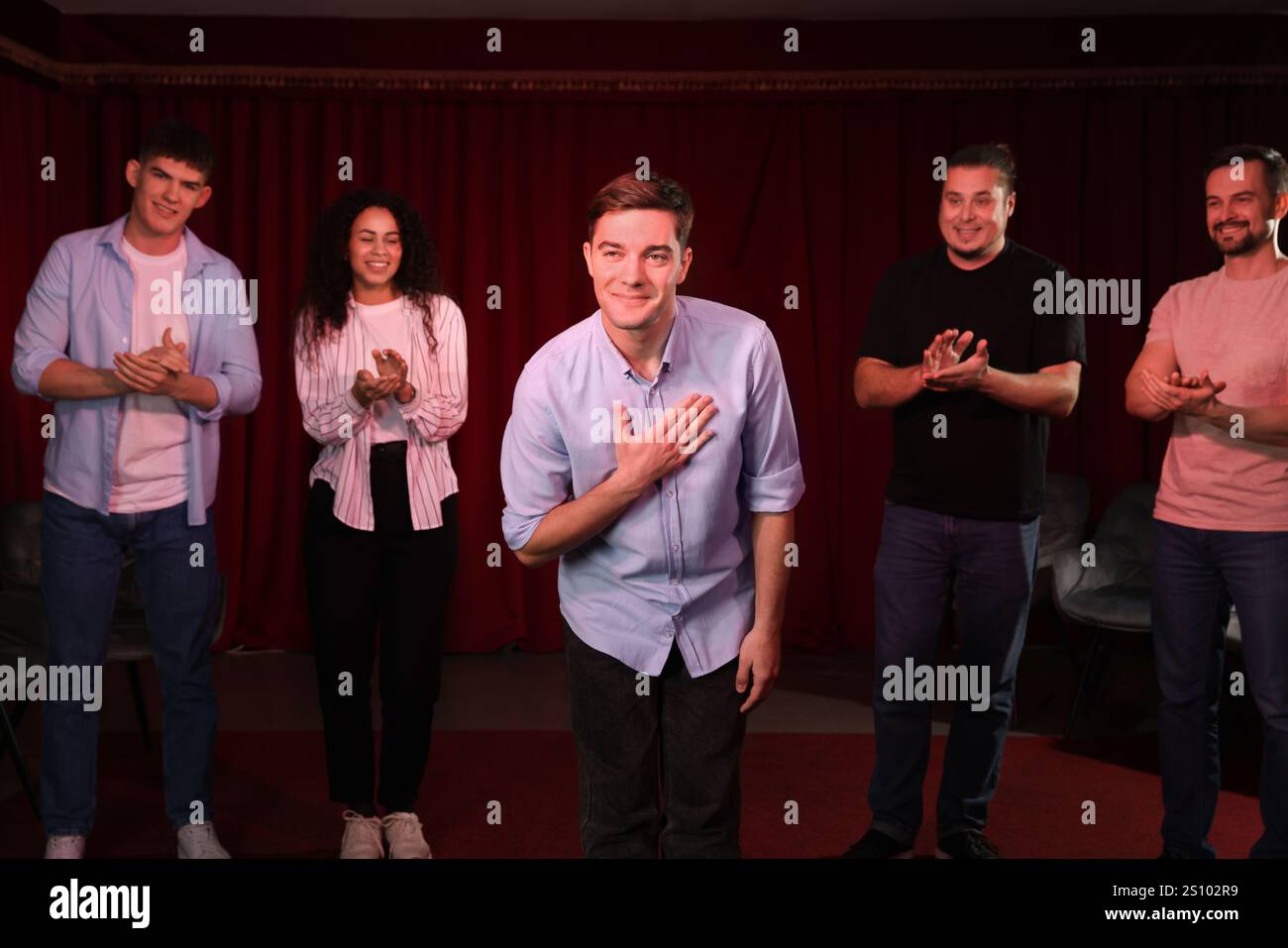 Professional actors bowing on stage in theatre Stock Photo - Alamy