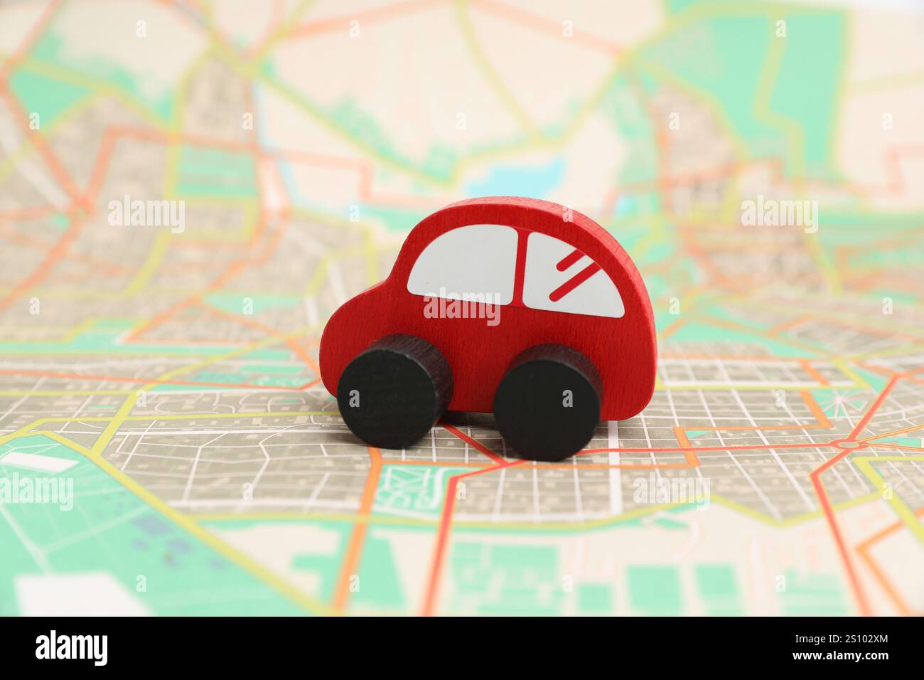 Red toy car on city map. Road trip Stock Photo - Alamy
