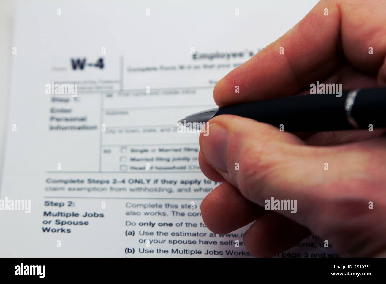 Hispanic male hand filling out writing w4 irs tax employee form Stock ...