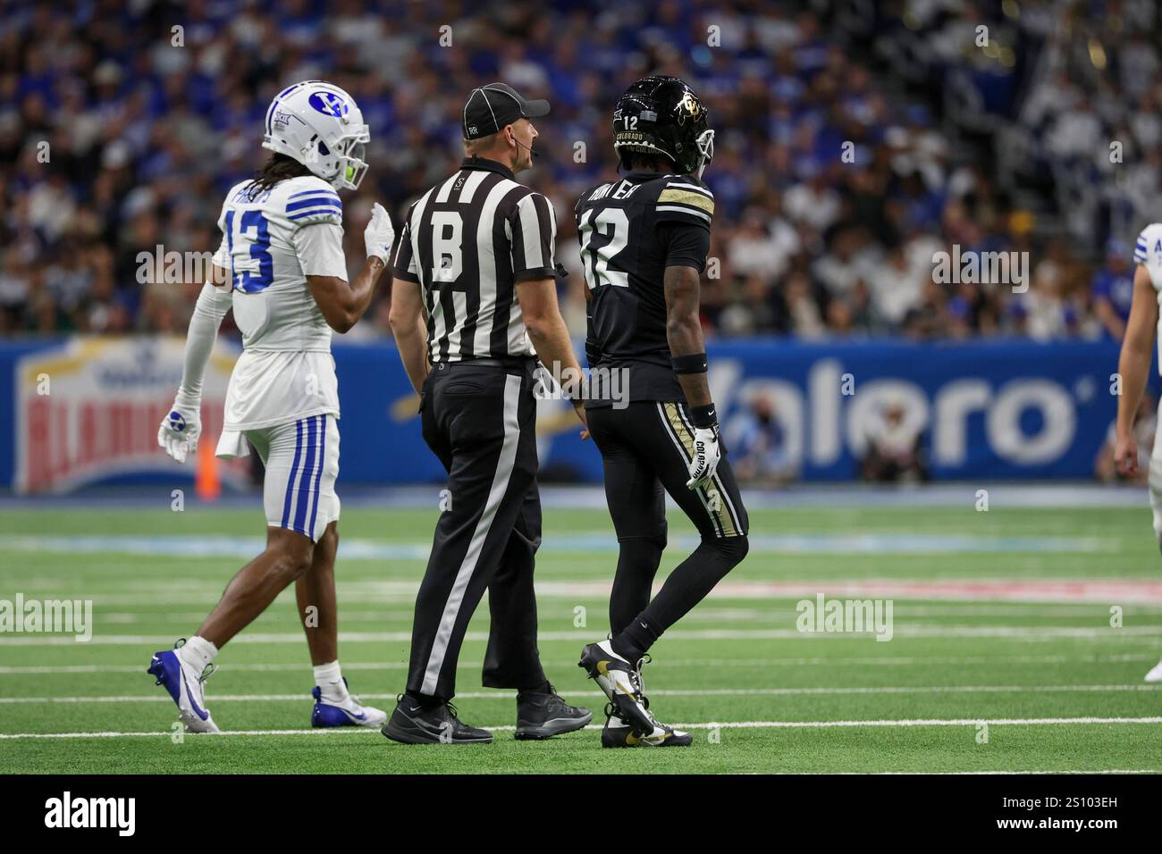 SAN ANTONIO, TX - DECEMBER 28: A referee stands between Brigham Young ...