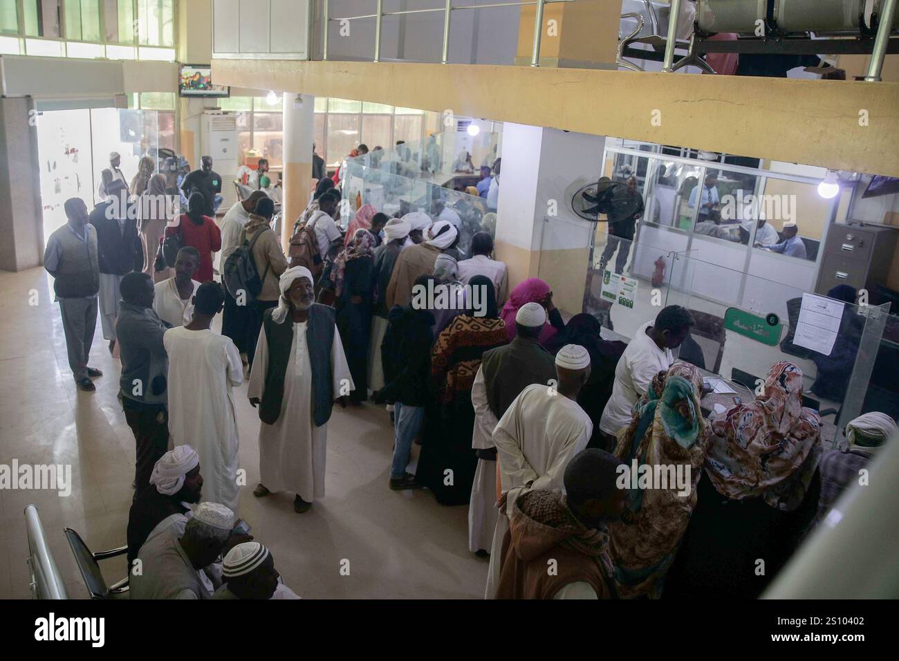 People queue to change their old currency to the new one, on the last ...