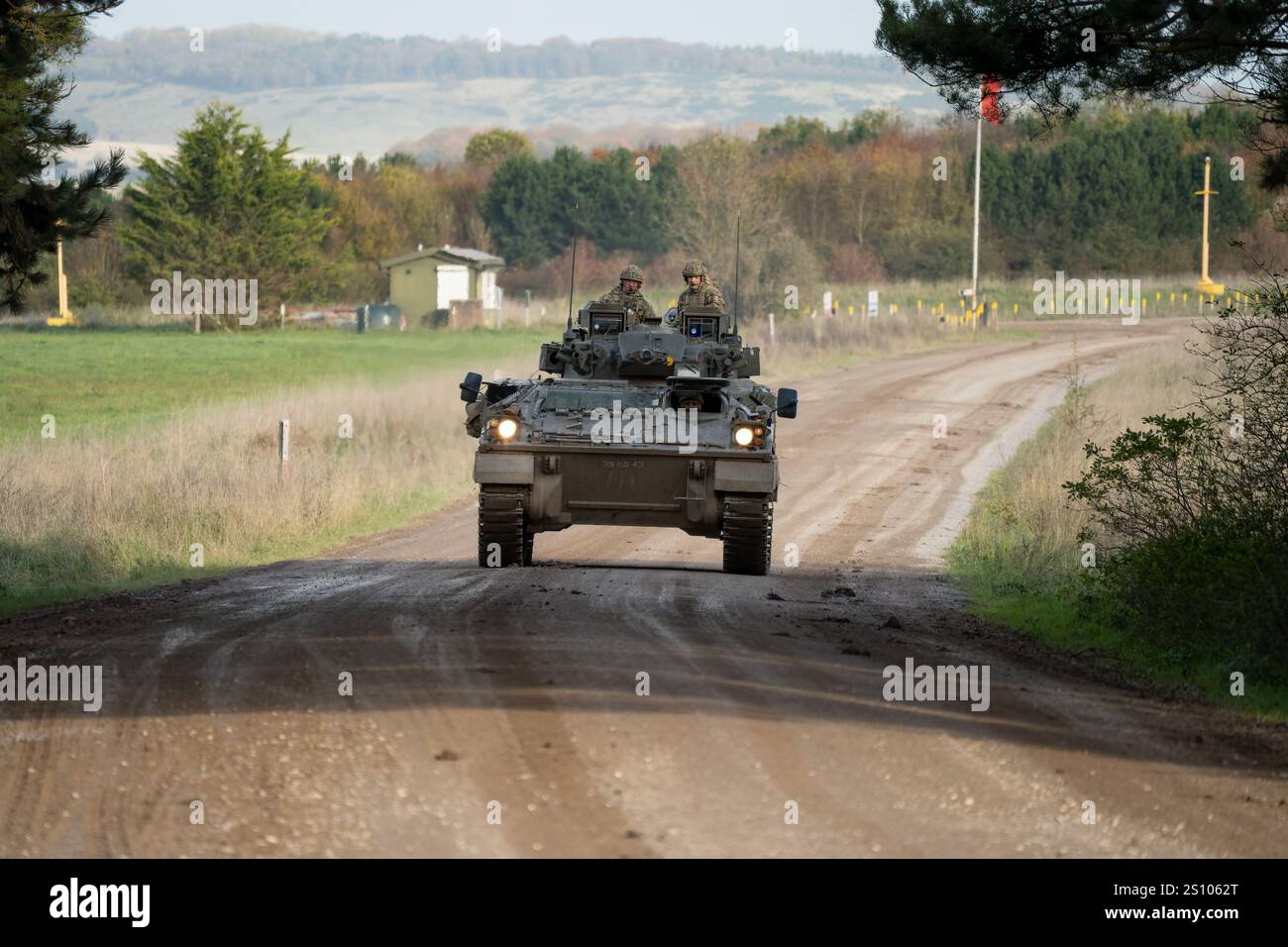Commander and gunner directing a British army Warrior FV510 IFV tank on ...
