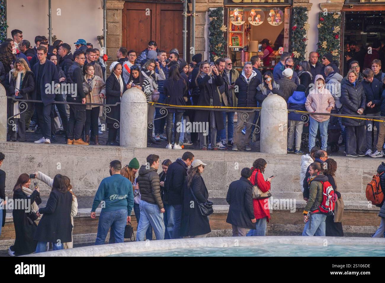 Rome, Italy. 30 December 2024 Large crowds gather at the Trevi fountain ...