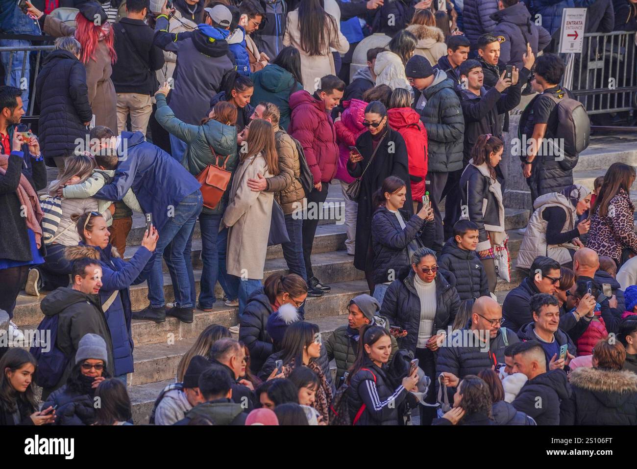 Rome, Italy. 30 December 2024 Large crowds gather at the Trevi fountain ...