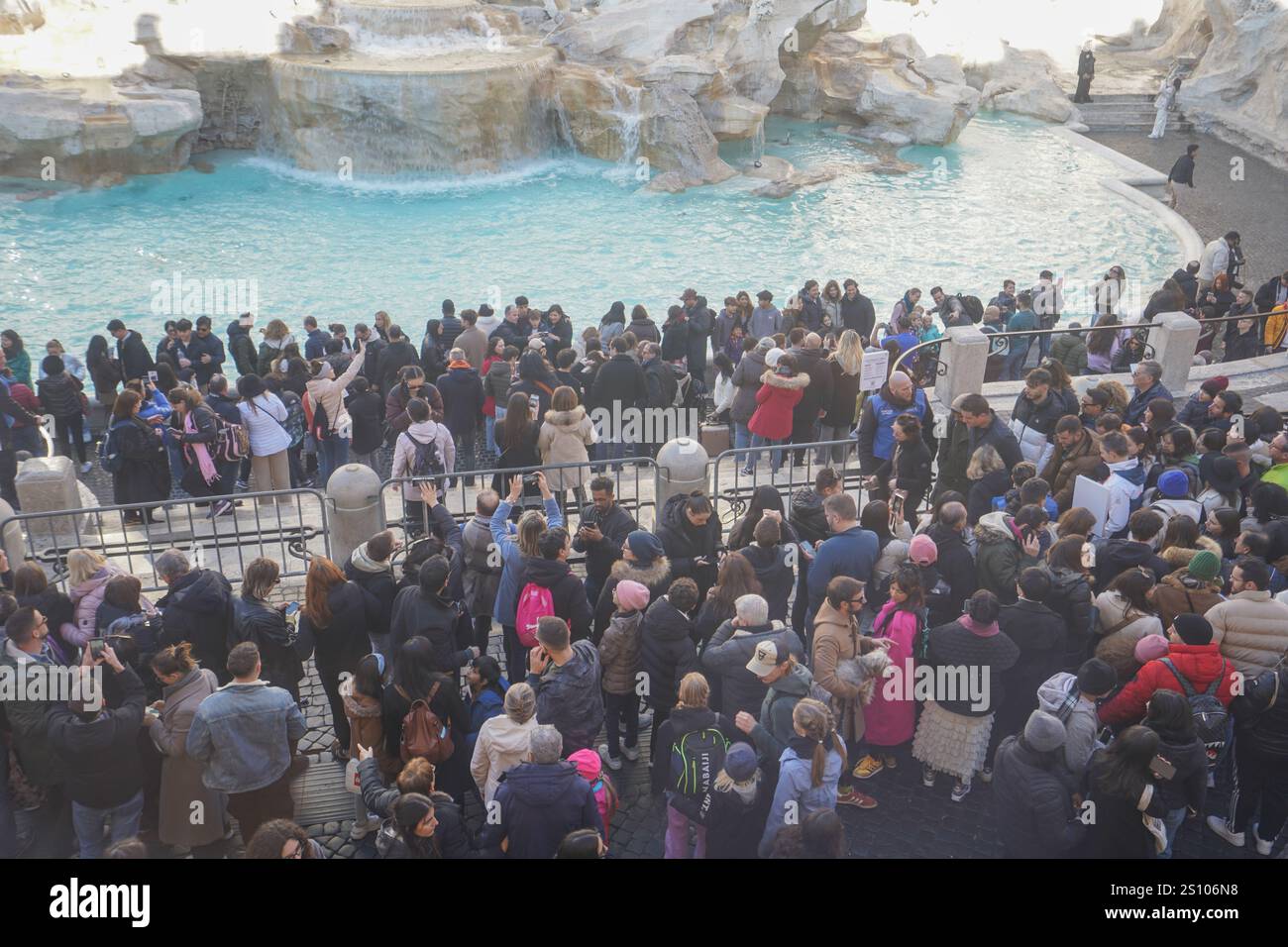 Rome, Italy. 30 December 2024 Large crowds gather at the Trevi fountain ...