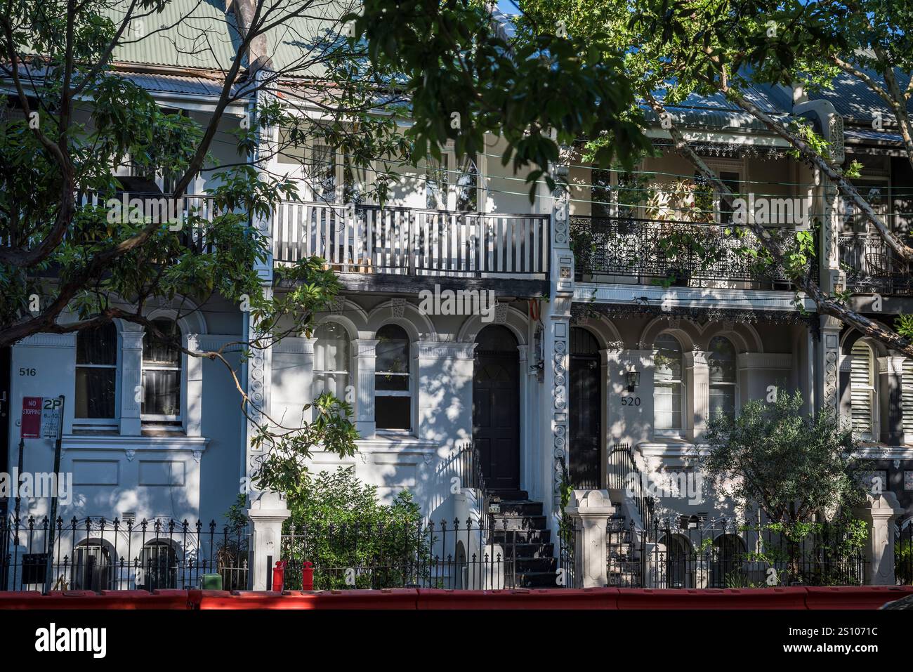 Residential Victorian-era houses adorned with ornamental iron lacework ...