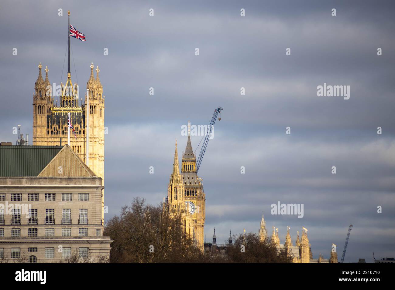 London, UK. 30th Dec, 2024. The UK flag was lowered to half-mast at the Houses of Parliament in ...