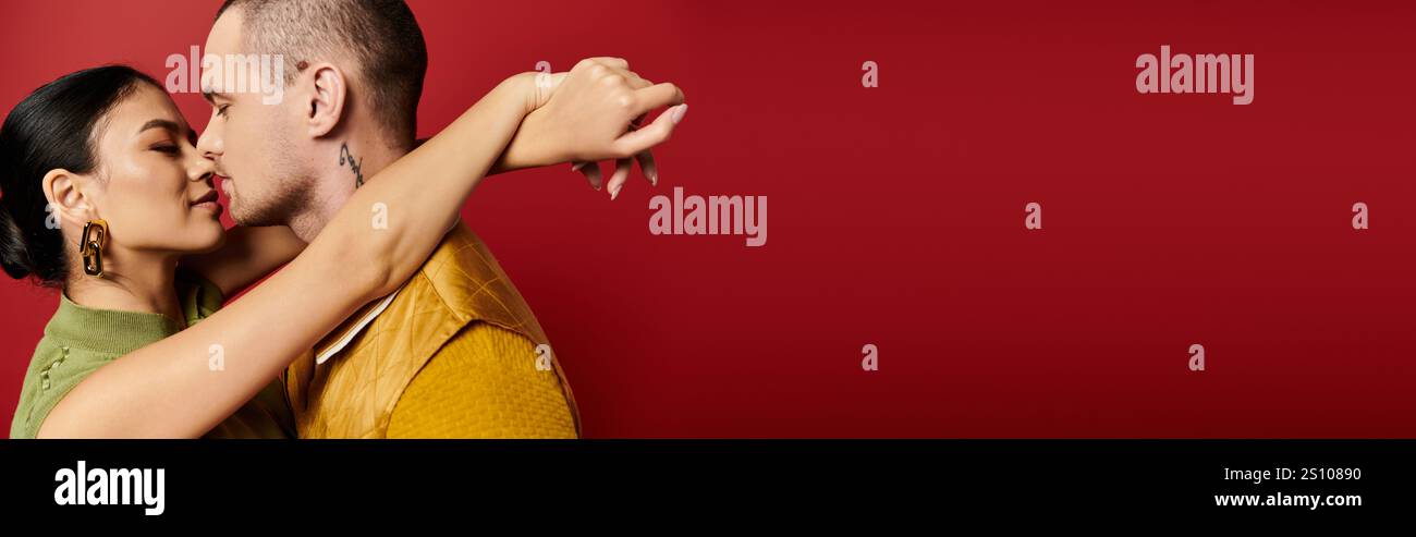 A beautiful young couple shares an intimate moment in a studio ...