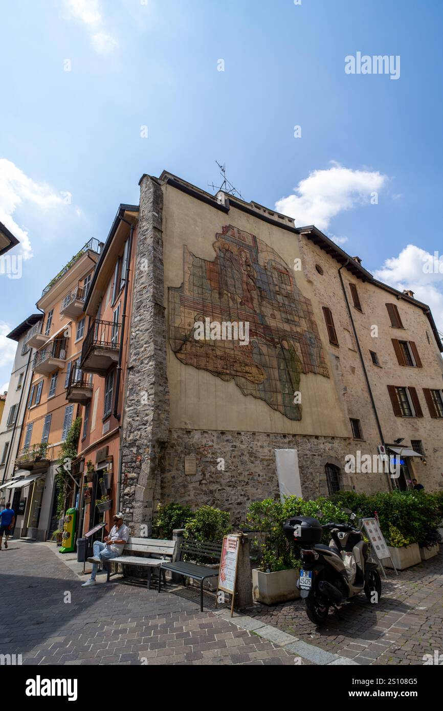 A historic mural painted on the side of a stone and stucco building in ...