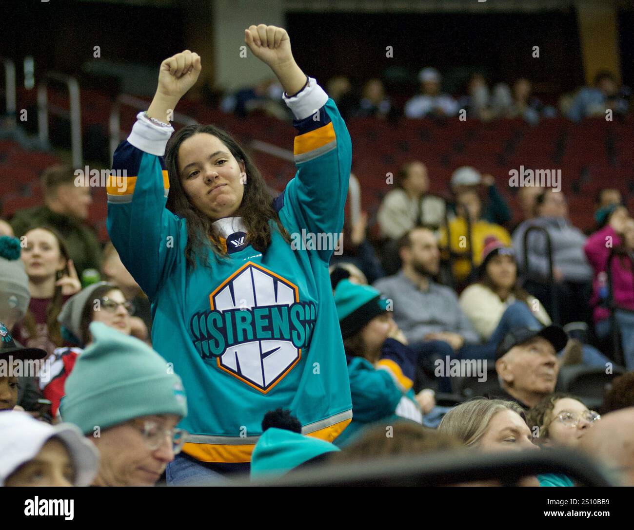 Newark, USA. 29th Dec, 2024. A Sirens fan cheers during Sunday's PWHL ...