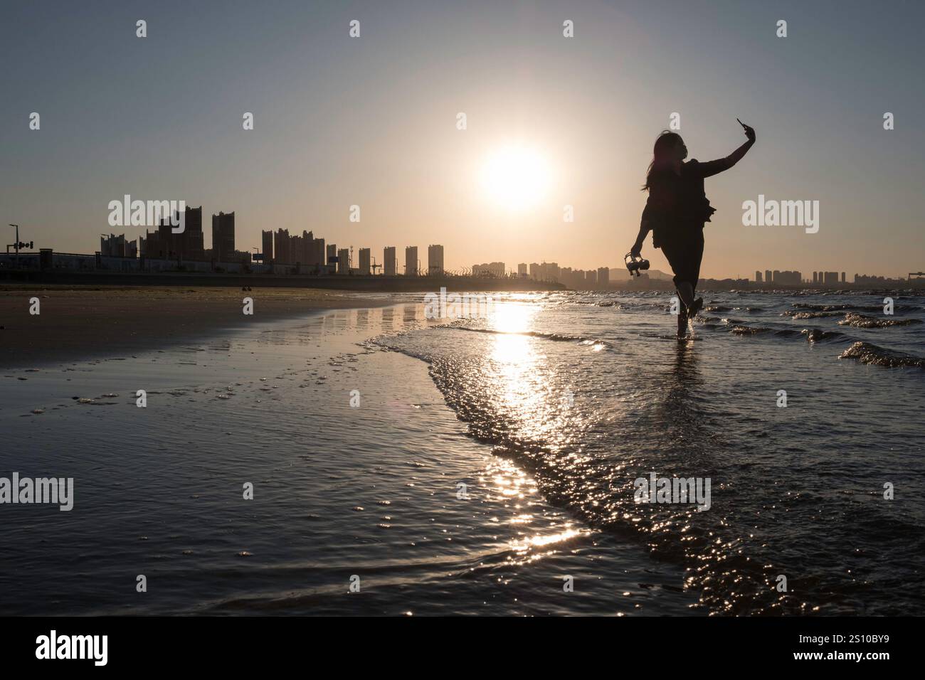 China, Yantai, 2017-06-01, sunset, sea, beach, shadows, woman, woman ...