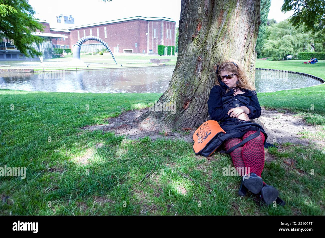 Beauty Sleeper in Park. Young adult female doing a nap while sitting ...