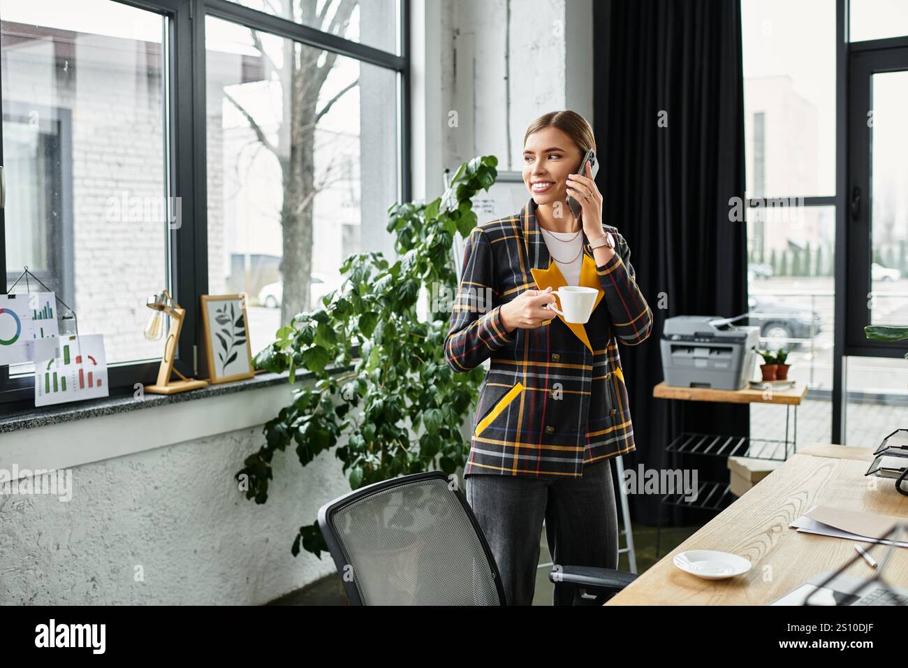 A professional woman enjoys her coffee while engaged in a phone ...