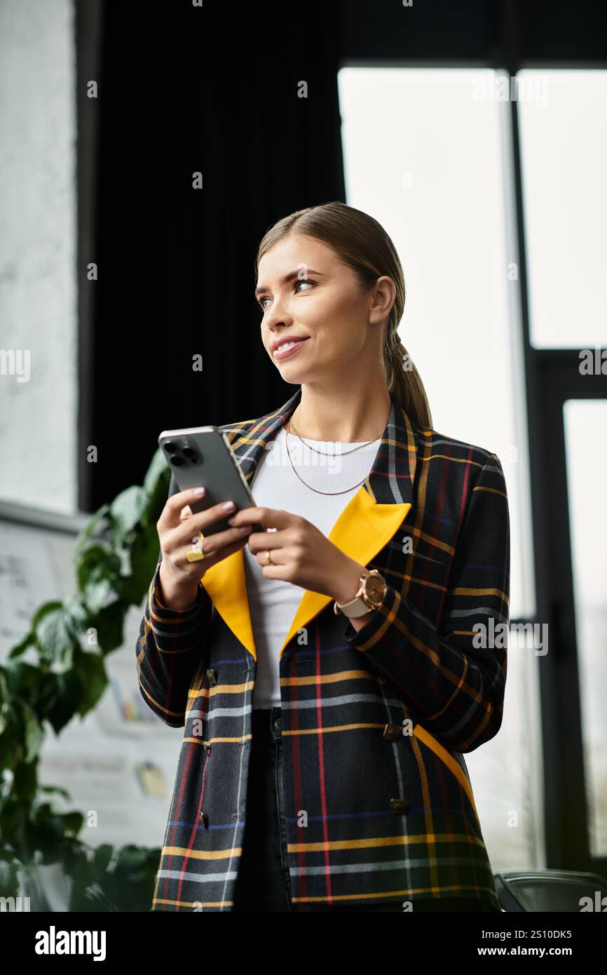 An attractive young woman in a chic checkered blazer engages with her ...