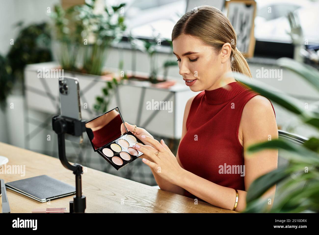 Young woman streams live, sharing her favorite beauty products while ...