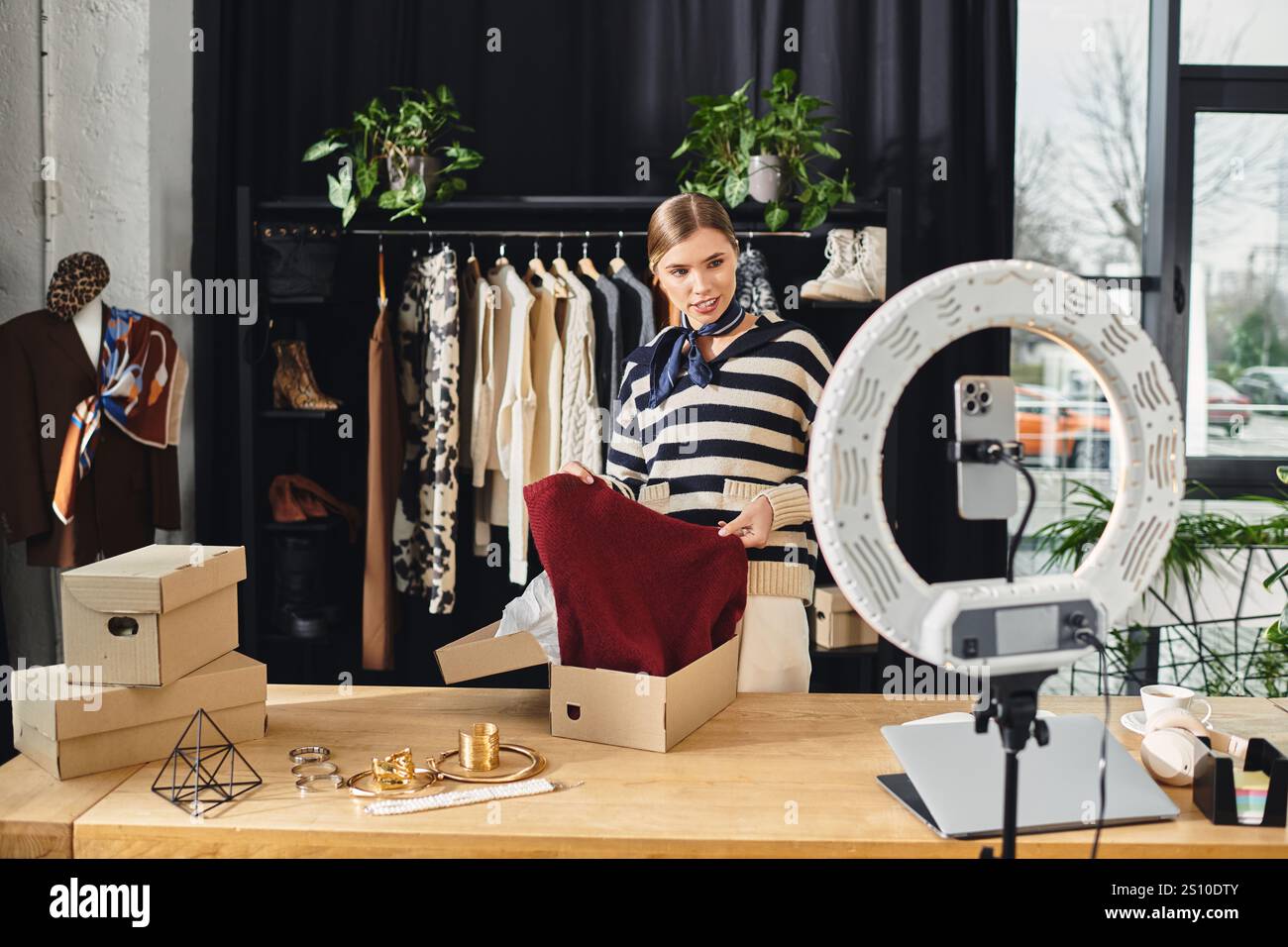 Young woman selects stylish clothes while filming her fashion tips for ...