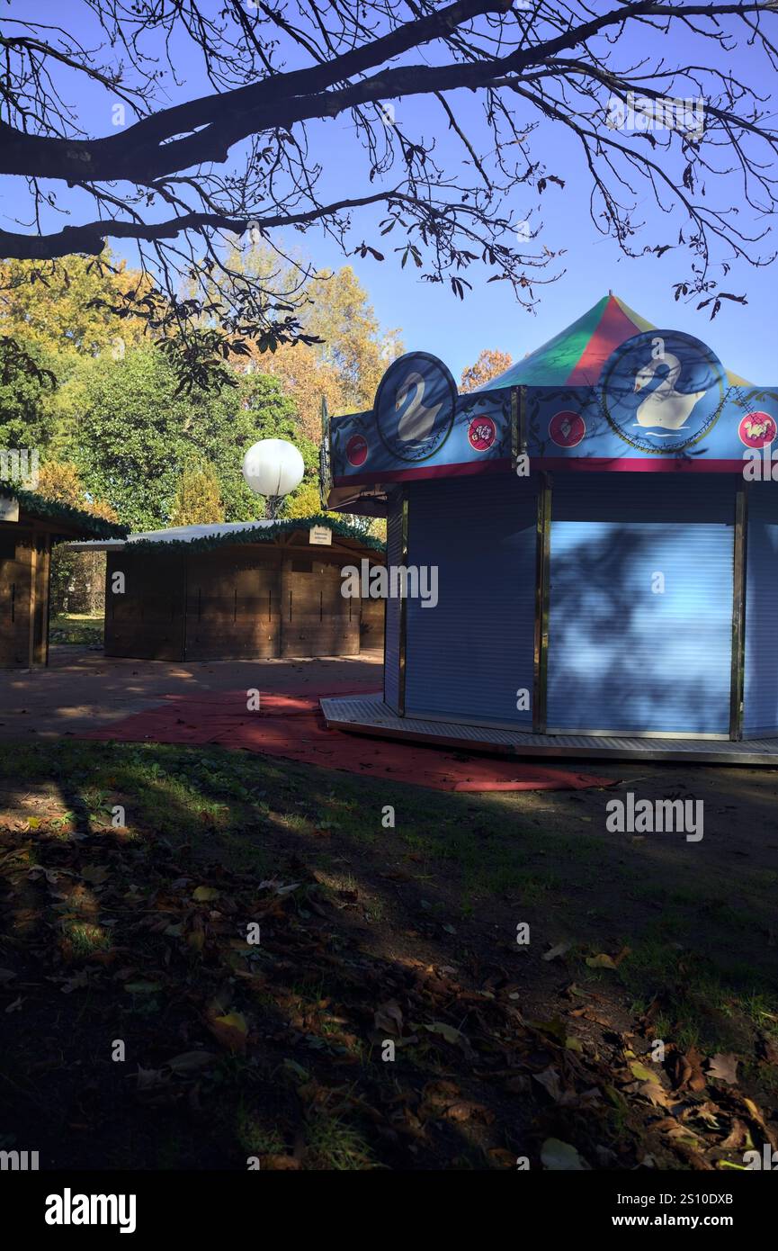 Game stall on a path next to wooden kiosks of a closed Christmas market ...