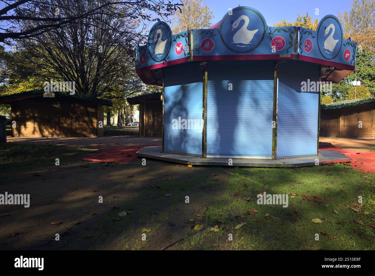 Game stall on a path next to wooden kiosks of a closed Christmas market ...