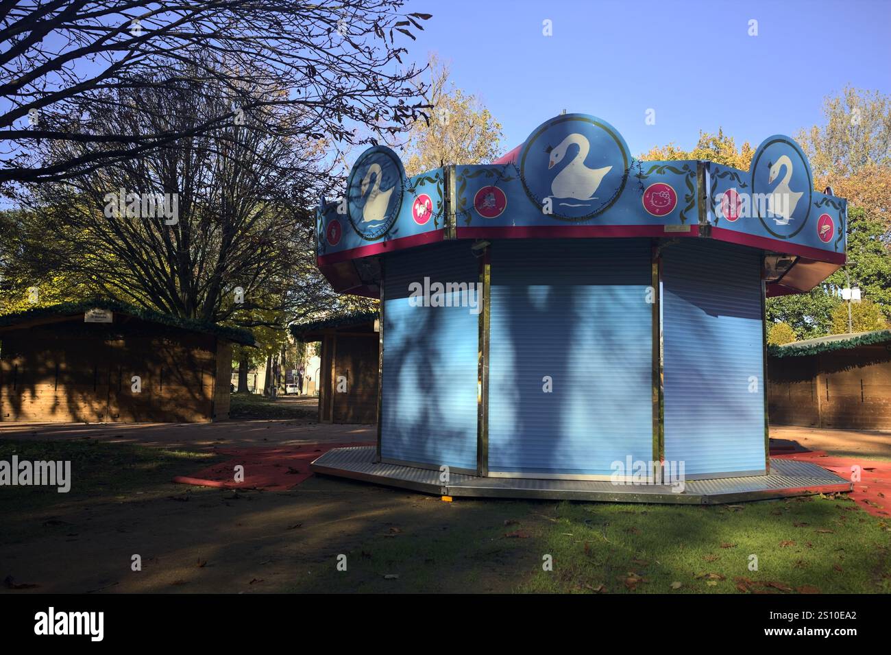 Game stall on a path next to wooden kiosks of a closed Christmas market ...