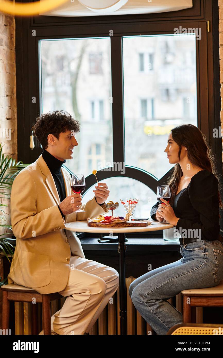 Young couple shares a special moment over dinner and drinks in a ...