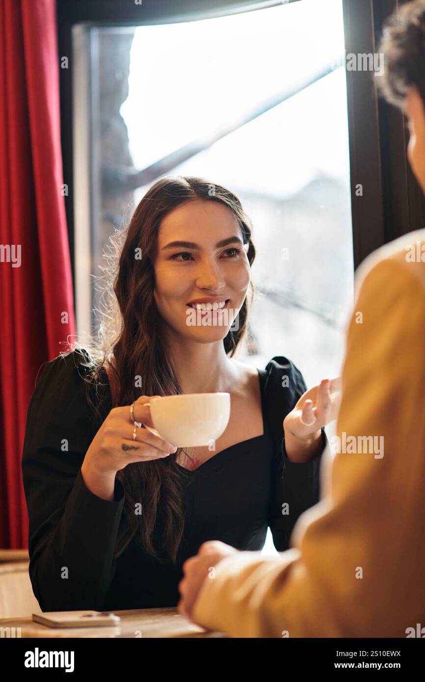 A young couple shares smiles and love over drinks in a cozy setting ...