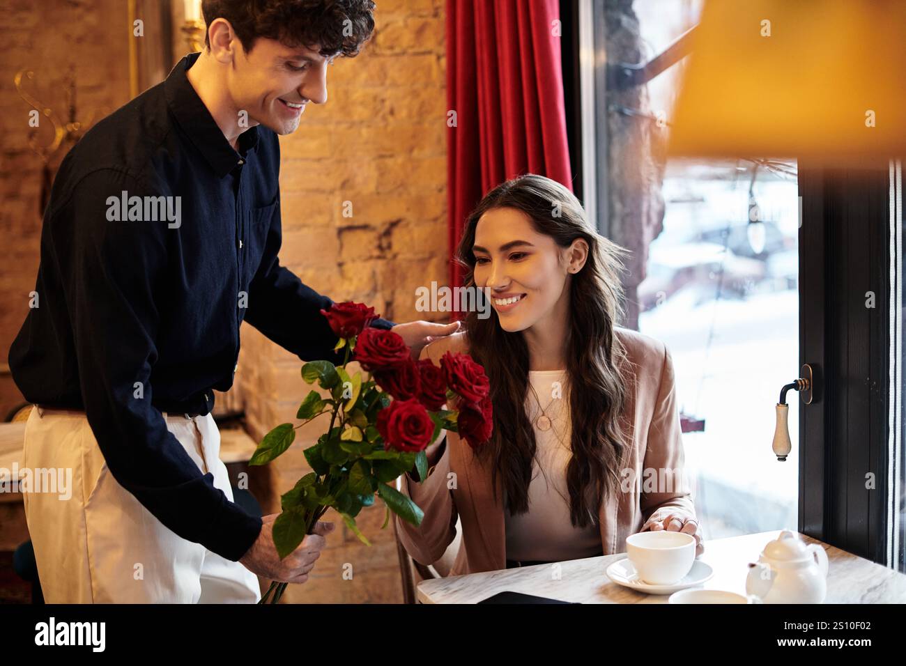 A young couple celebrates their love with roses and smiles at an ...
