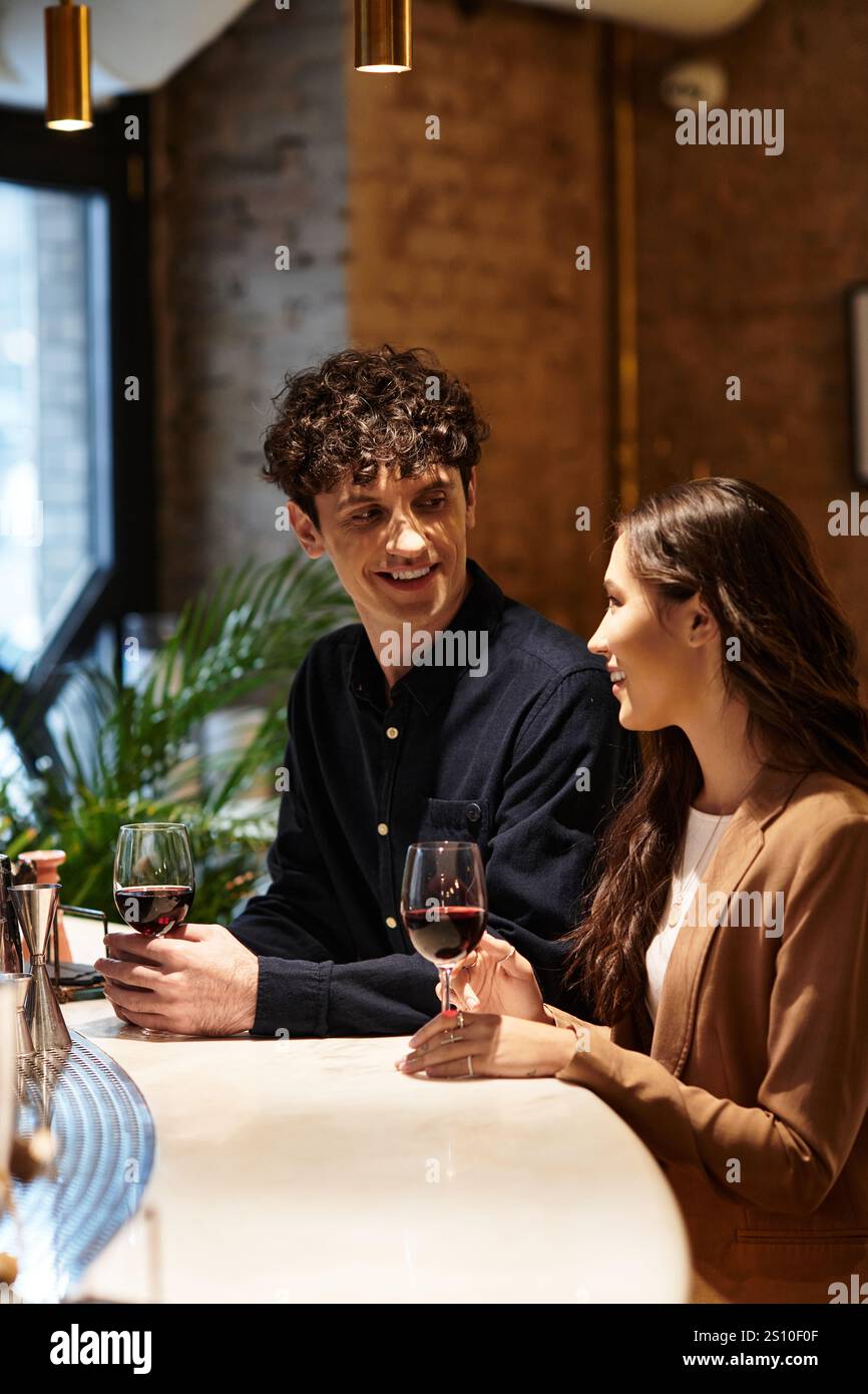 A young couple enjoys a charming Valentines Day dinner, sharing smiles ...
