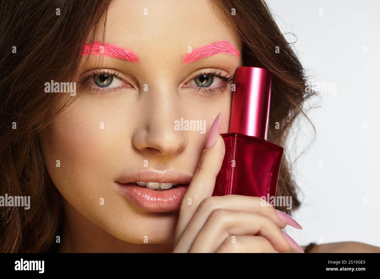 An attractive young woman showcases her bold style with pink eyebrows ...