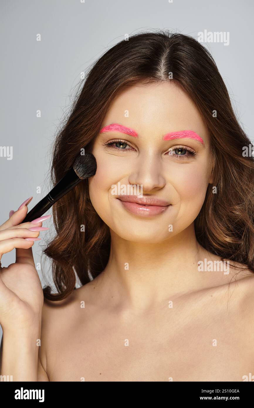Young woman highlights her vibrant pink eyebrows while showcasing a ...