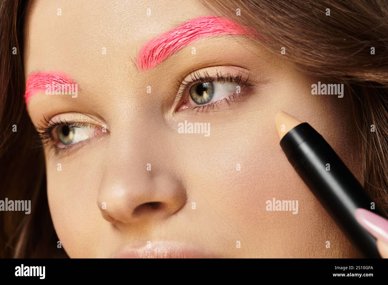 Attractive young woman showcases her striking pink eyebrows while ...