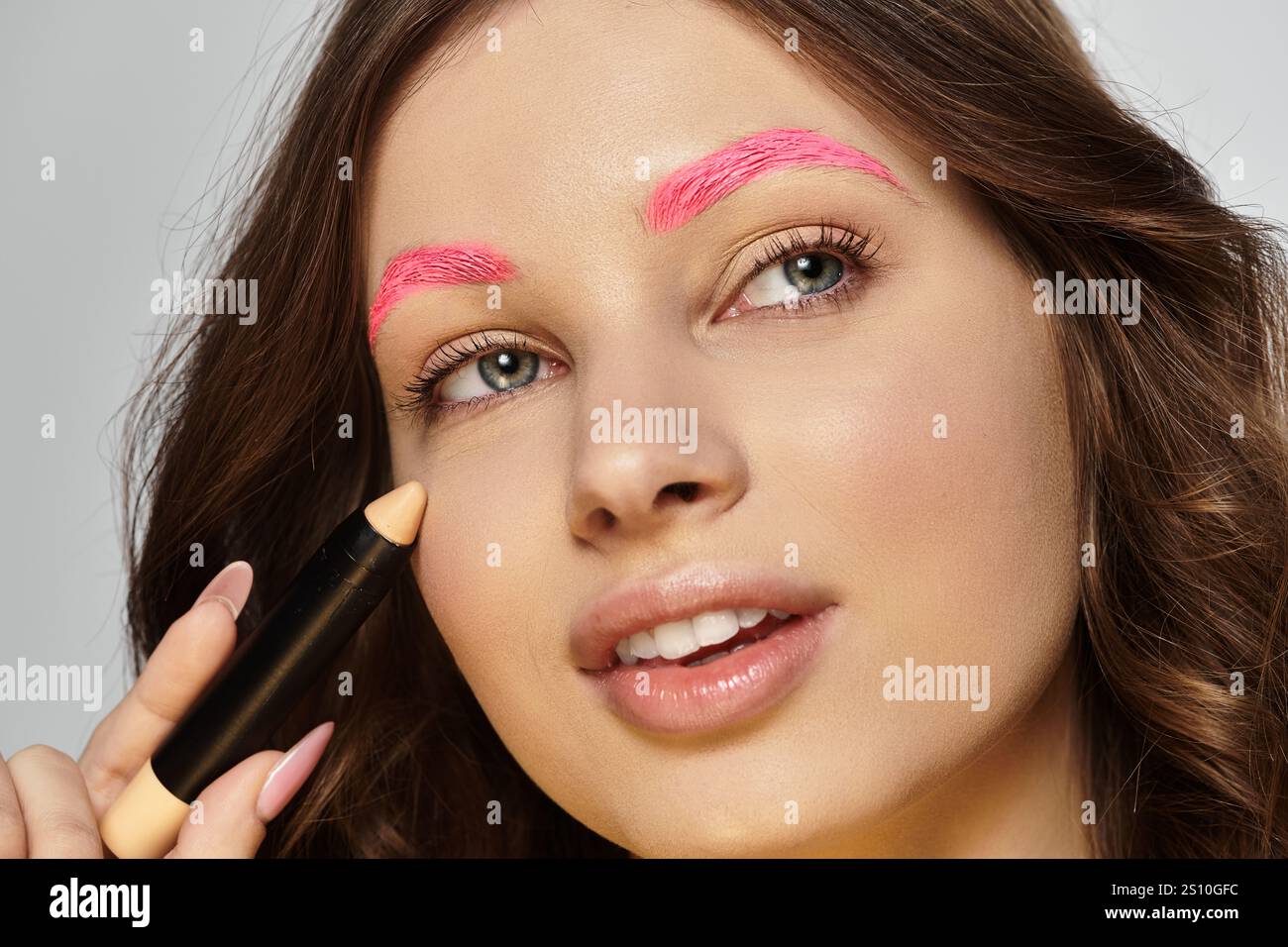 Attractive young woman with pink eyebrows highlights her bold style ...