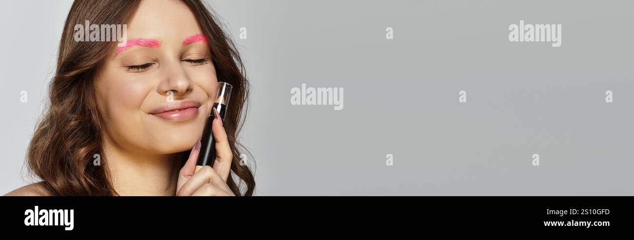 Young woman showcases her unique style with vibrant pink eyebrows and a ...