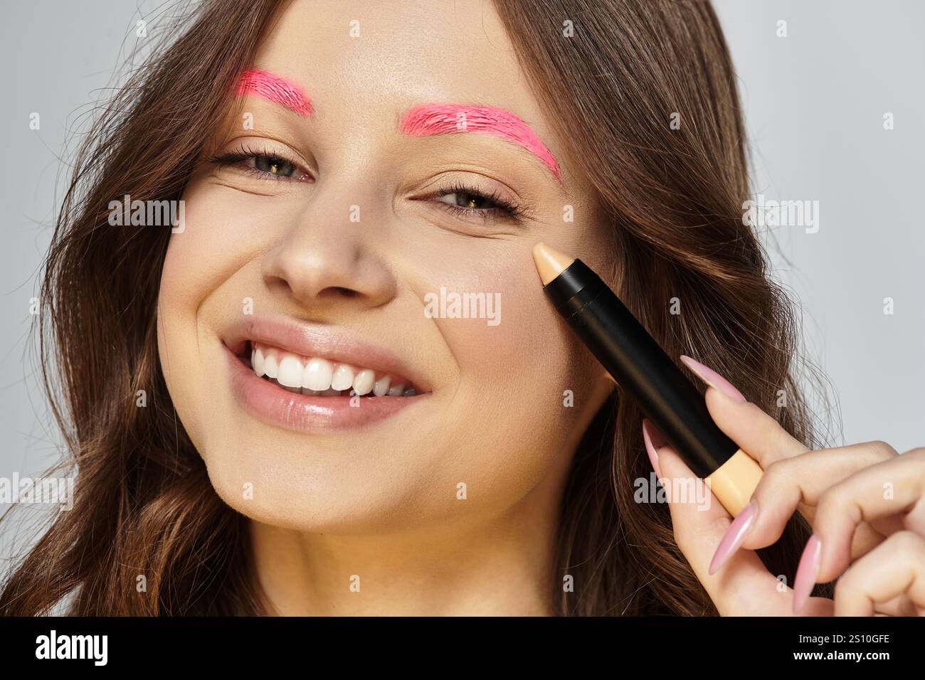 Young woman highlights bold style and unique pink eyebrows while posing ...