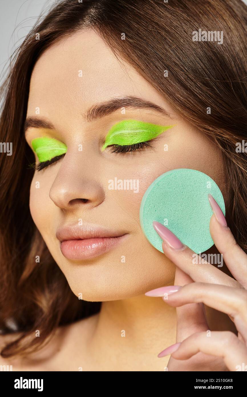 Young woman showcases striking green eyeshadow and bold makeup while ...
