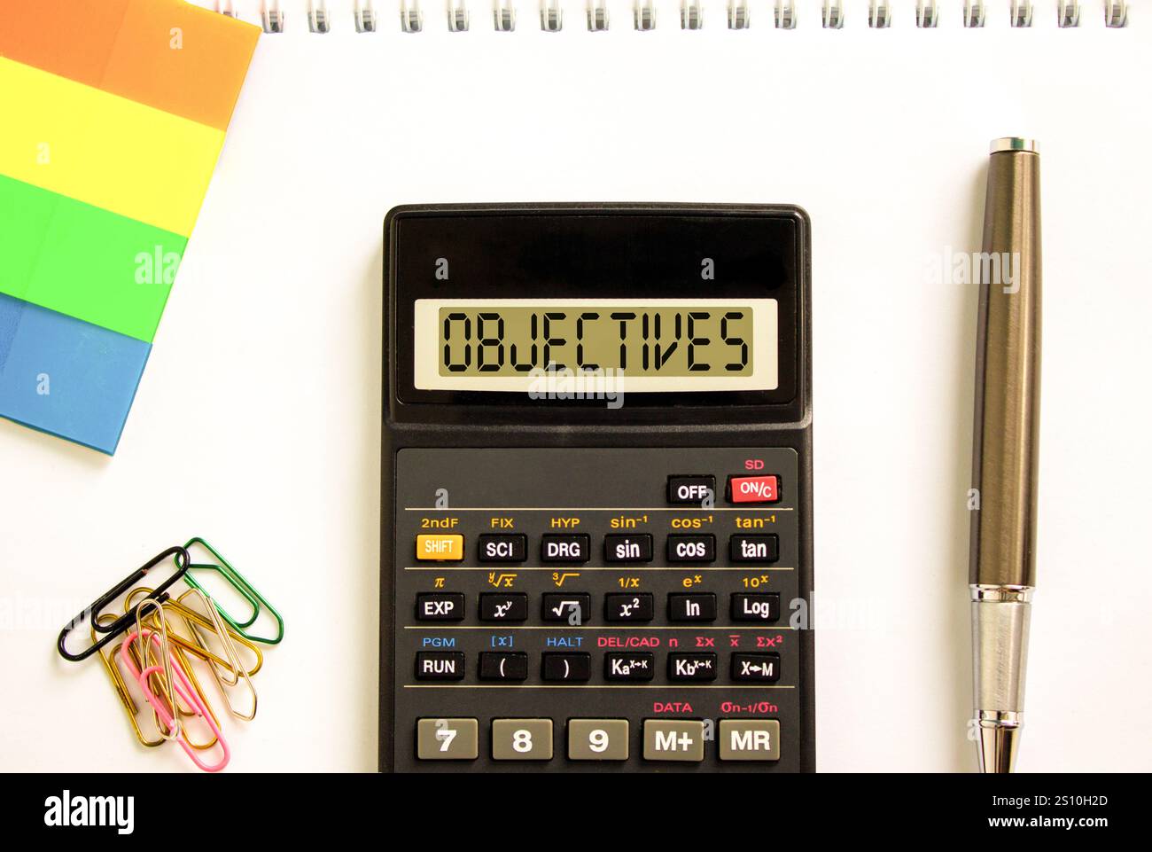 Objectives symbol. Concept word Objectives on beautiful black calculator. Beautiful white paper ...