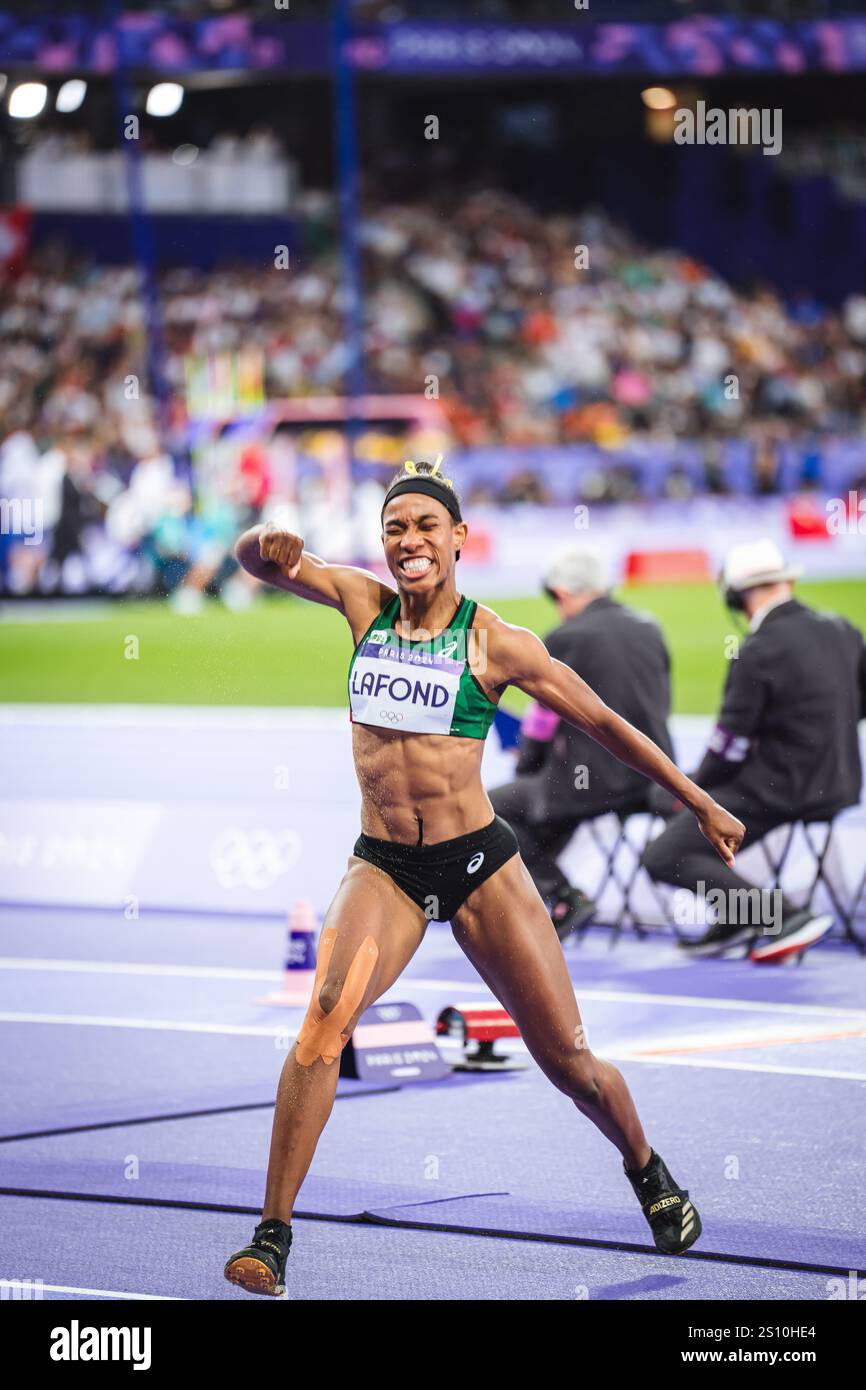 Thea LaFond celebrating her medal with her country's flag at the Paris ...