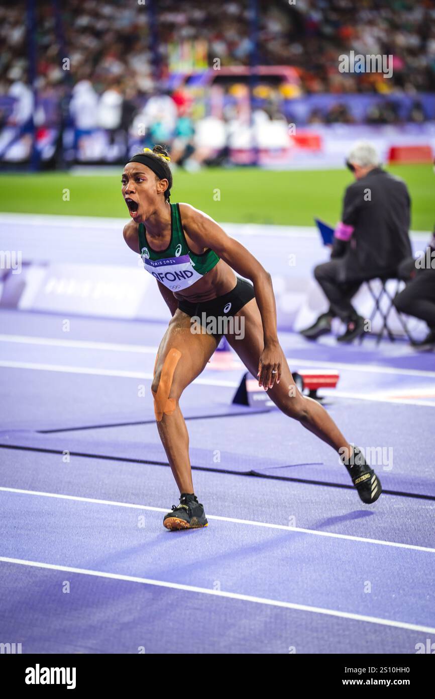 Thea LaFond celebrating her medal with her country's flag at the Paris ...