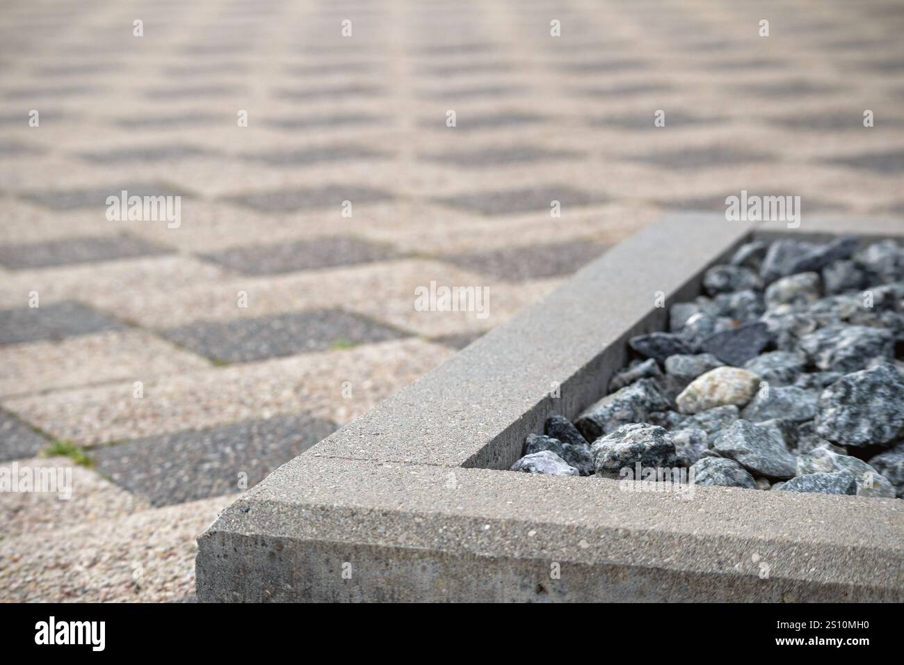 A pavement of small gray concrete blocks arranged in a checkerboard ...