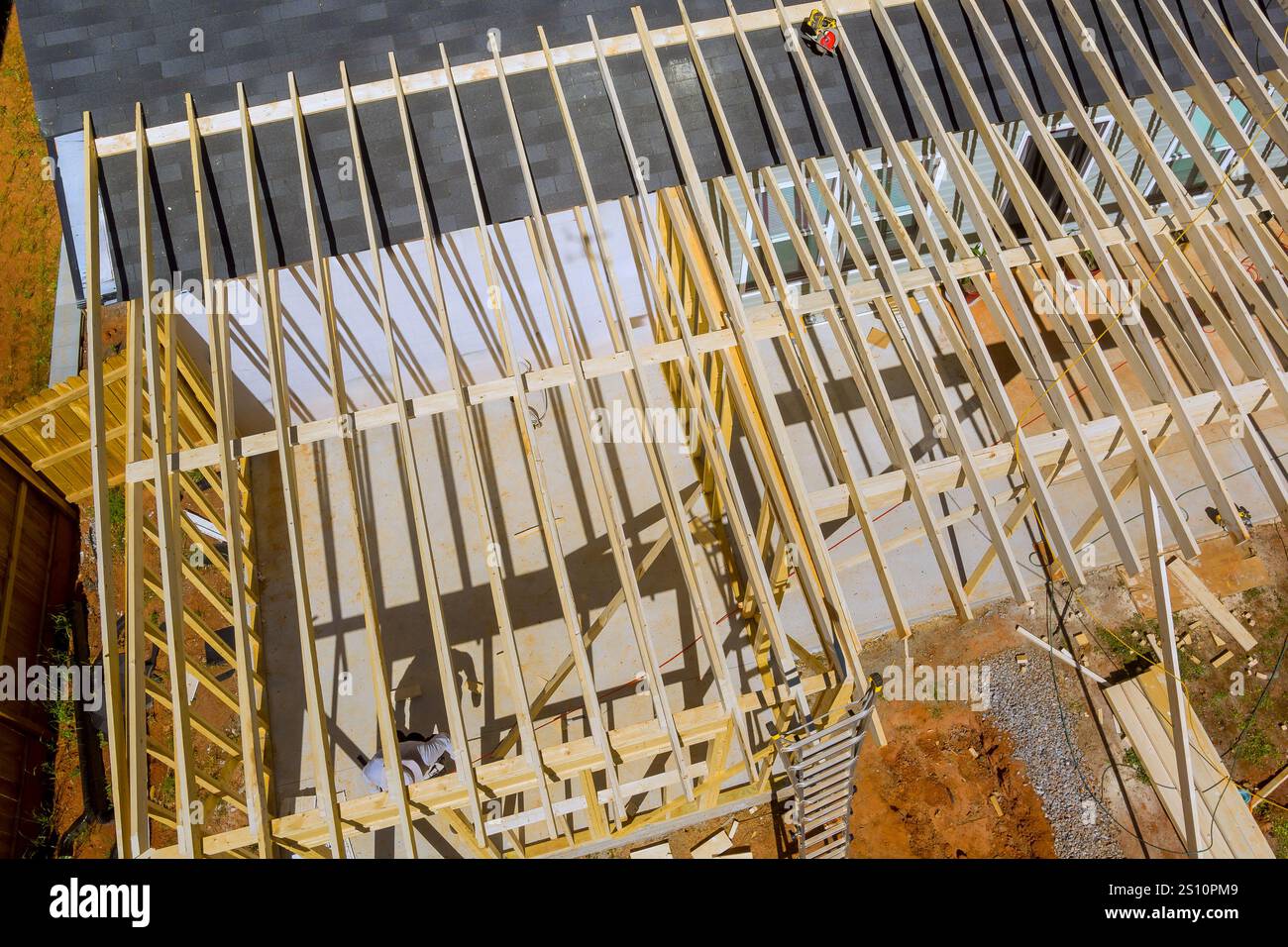 Workers are assembling wooden frames roof beams for building roofing ...