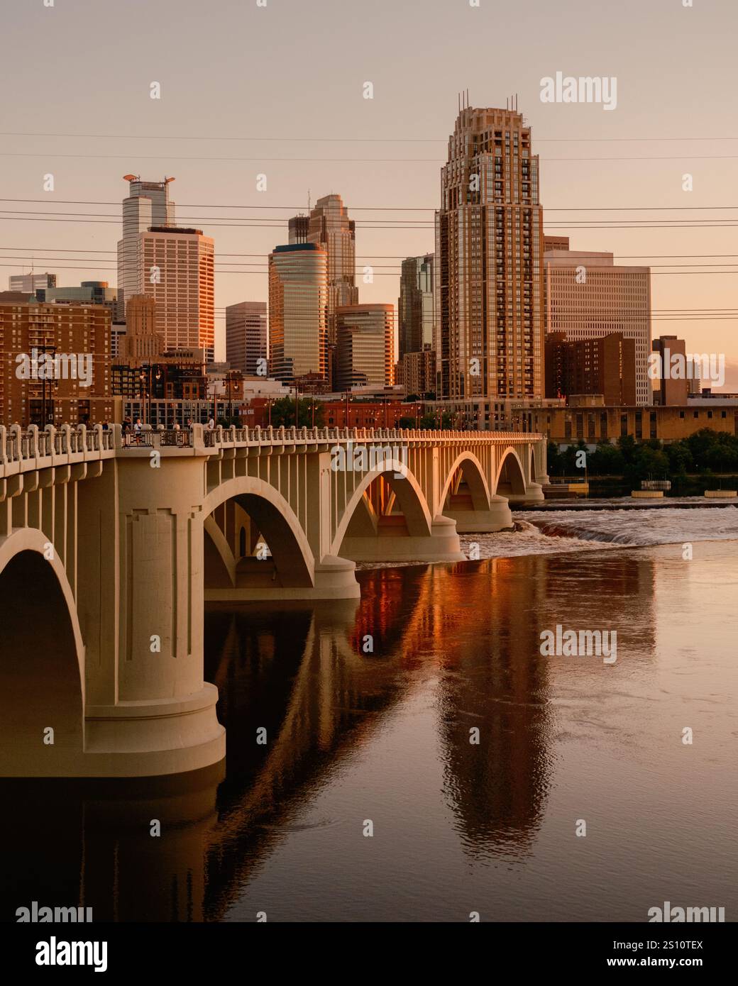 The Minneapolis skyline and Third Avenue Bridge at sunset in ...
