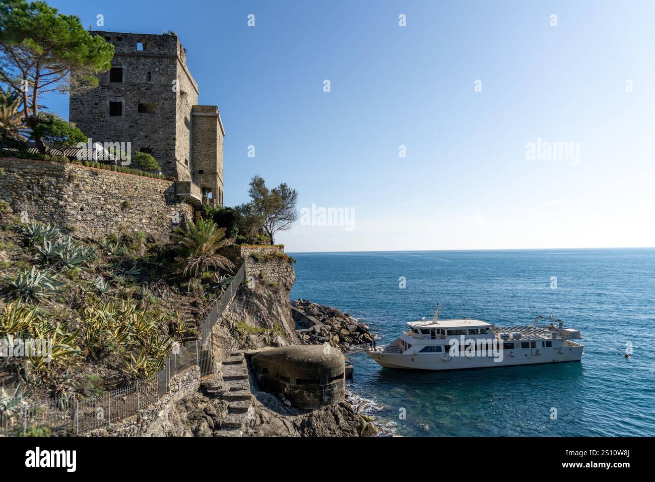 A passenger ferry boat docks at below the medieval Aurora Tower at ...
