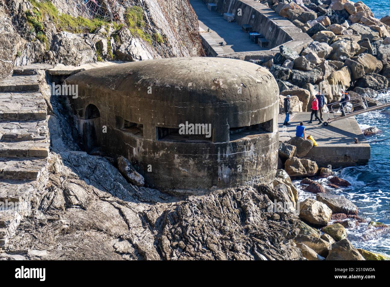 A concrete machine gun emplacement or pillbox from World War II at ...
