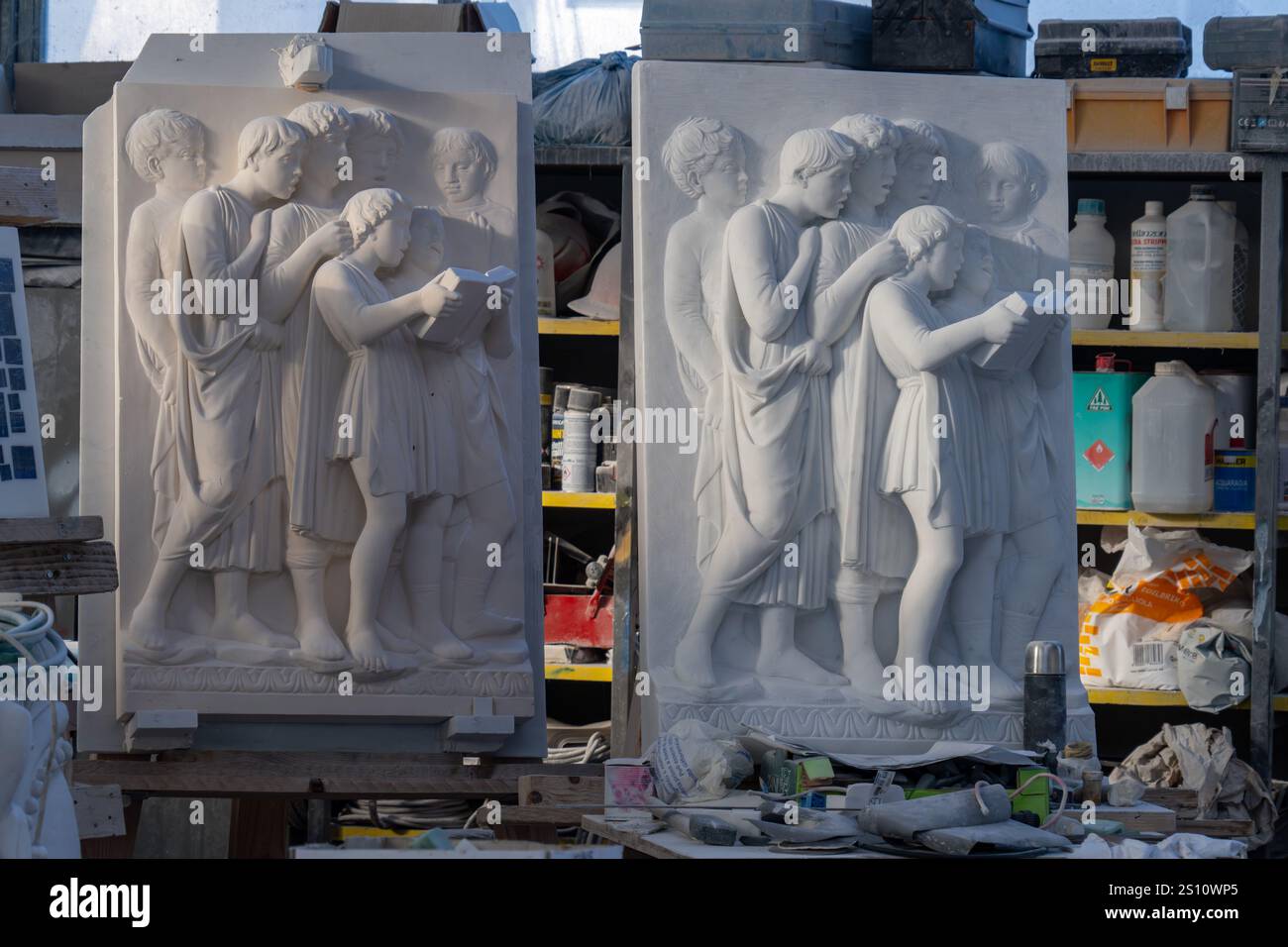 A cast resin model and finished bas relief marble sculpture in a marble ...