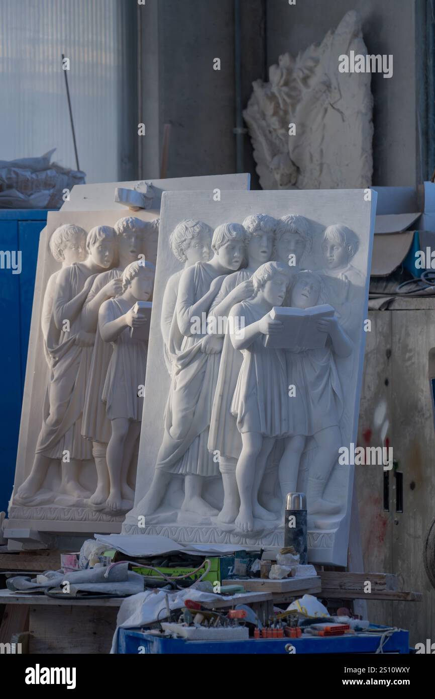 A cast resin model and finished bas relief marble sculpture in a marble ...