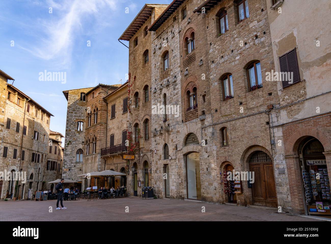 Medieval buildings around the Piazza della Cisterna in the walled city ...