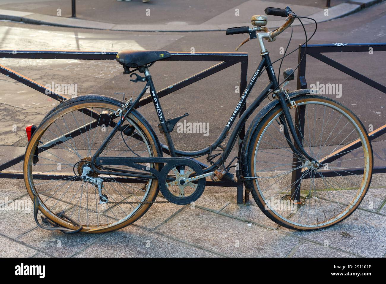 Paris, France, 12.26.2024. A very rusty bike attached to the railing in ...