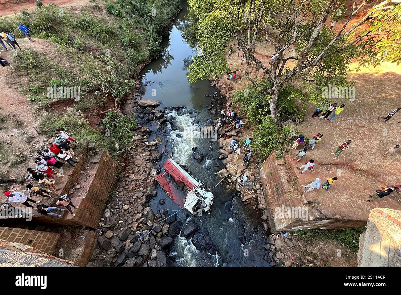 People view a truck that fell off the Gelan Bridge as it was returning from a wedding ceremony ...