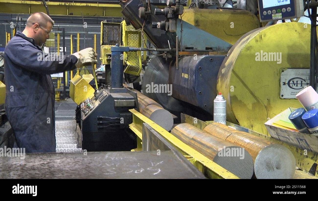 Employee using cutting saw in Forge Shop Stock Photo - Alamy